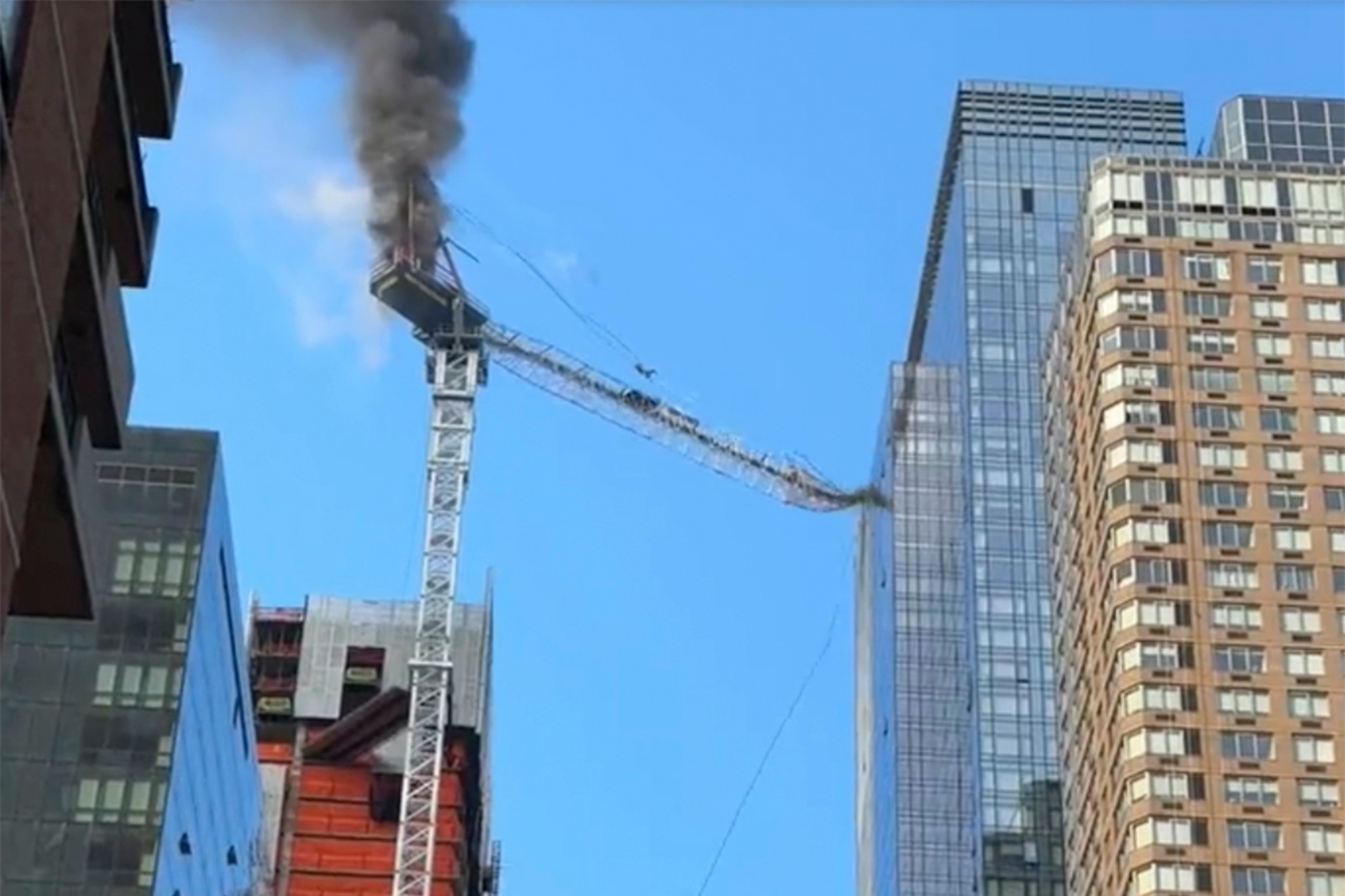 Massive crane fire causes partial collapse and wreaks havoc below in ...